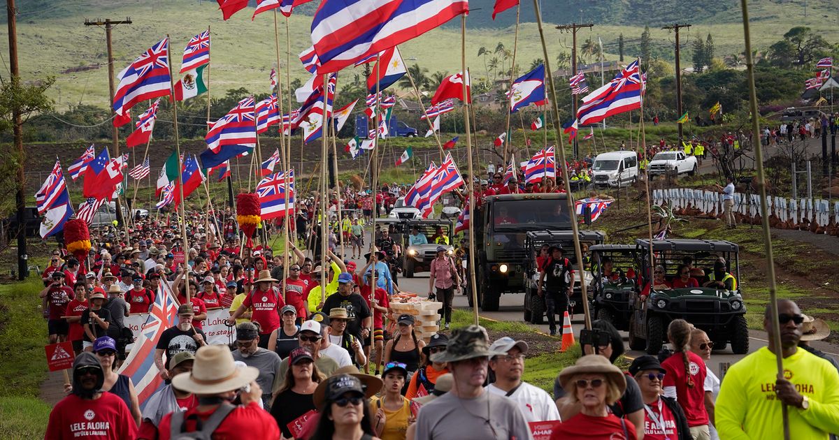 Many participants in the unity march wore red shirts, a color that has ...